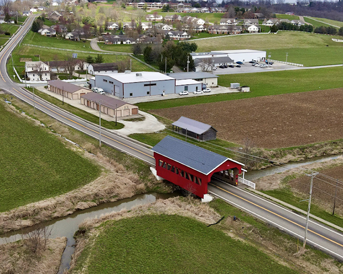 From above, the red covered bridge looks like a toy model placed perfectly in this real-life diorama of rural American life.