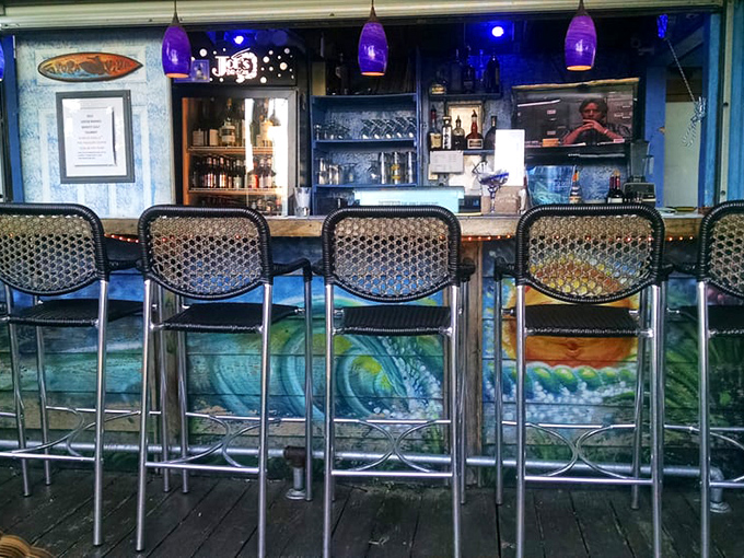 A bar that promises good conversations and better cocktails. Those purple pendant lights add just the right touch of coastal cool.