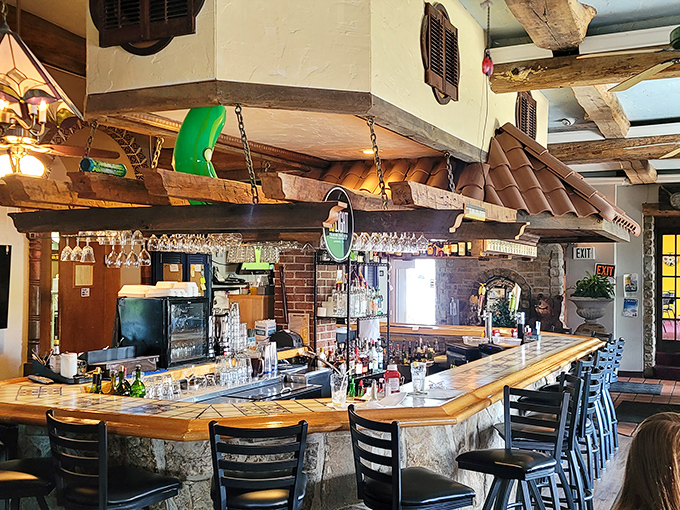 A bar that tells stories: exposed beams, hanging glassware, and the promise that whatever's troubling you can wait until after your second drink.