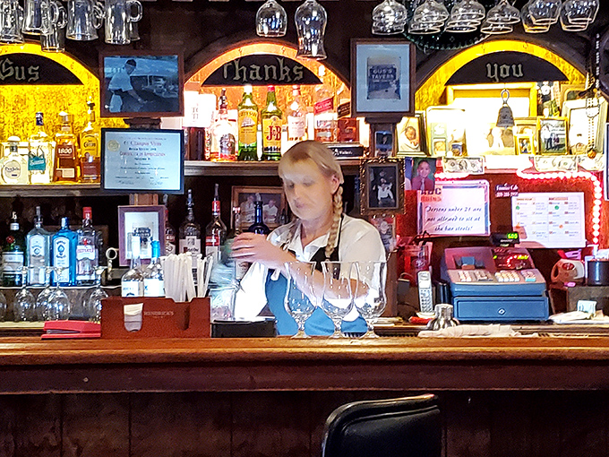 Behind every great steakhouse is a well-stocked bar with a bartender who's seen it all. The illuminated backdrop glows like the sunset over a perfectly grilled steak.