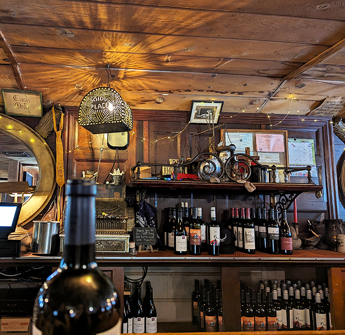 The bar area feels like a saloon from another era. Those bottles aren't just drinks&mdash;they're liquid companions to the stories you'll share around the wooden tables.