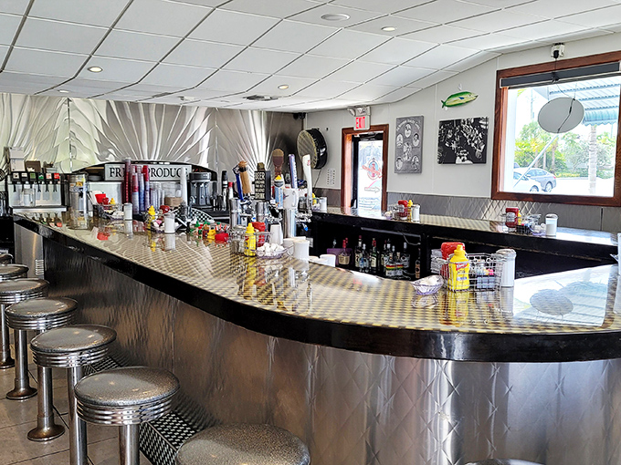 The classic diner counter where coffee flows freely and conversations spark between strangers turned temporary friends.