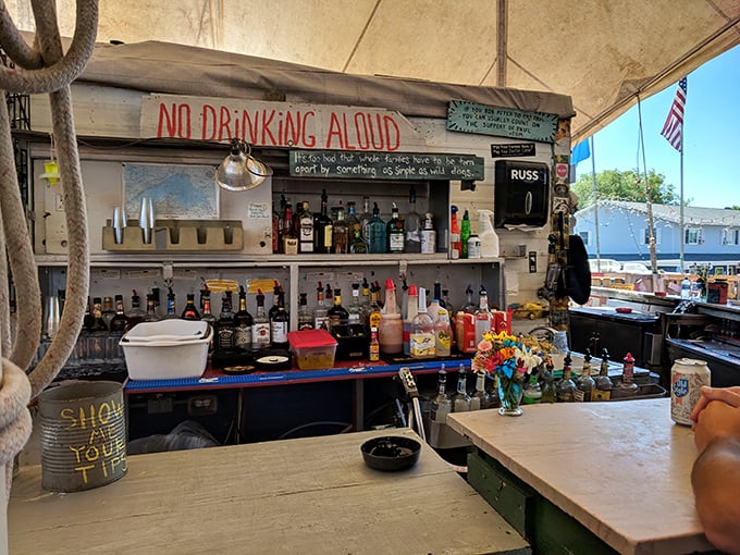 "NO DRINKING ALOUD" warns the sign, but the well-stocked bar below suggests quiet imbibing is heartily encouraged.