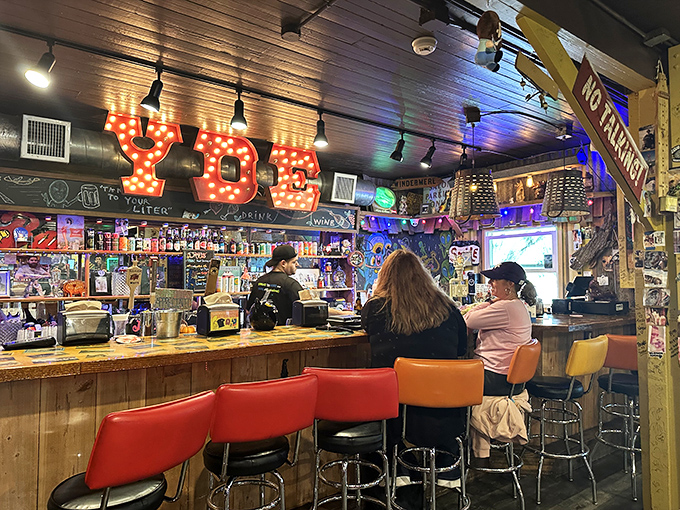 The bar area glows with neon promise and spirits of all varieties. Those stools have supported countless happy diners making important decisions about sauce selection.