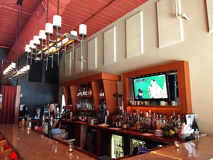 The bar area beckons with promises of perfectly crafted cocktails and conversations worth remembering forever.