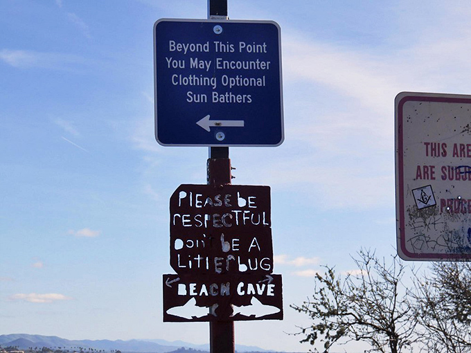 The sign that divides the beach into "family photo" territory and "maybe crop that out of the Christmas card" areas.