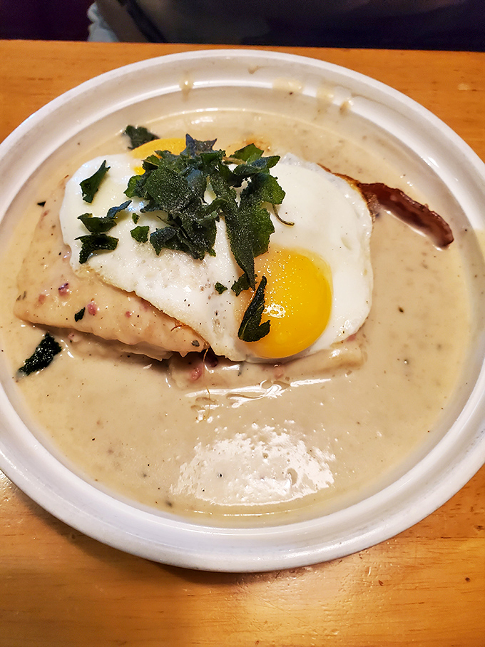 Behold: the legendary biscuits and gravy in their natural habitat. That sunny-side-up egg is the crown jewel of this comfort food kingdom.