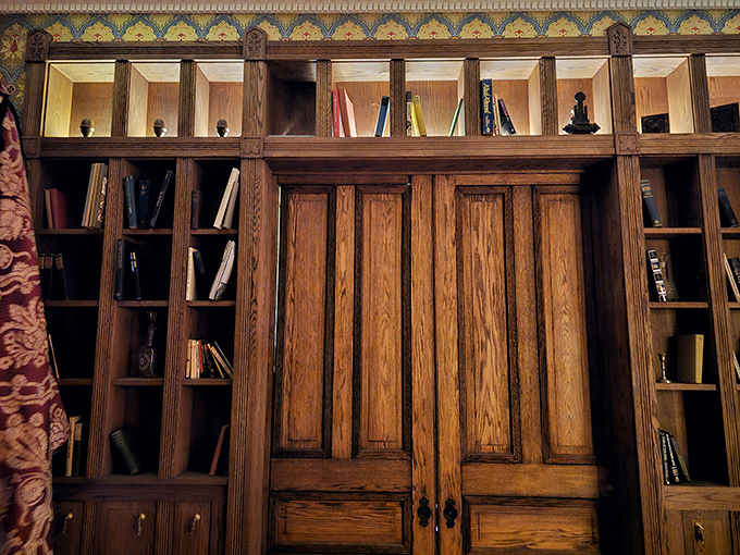 Behind these wooden panels, legend says secret passages await. The craftsmanship of these built-in bookshelves speaks to the mansion's original opulence.
