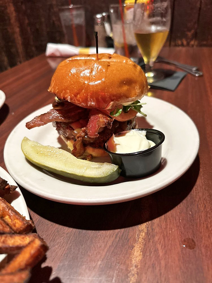 This bacon-topped burger isn't just food&mdash;it's architecture. The pickle stands guard like it's protecting a national treasure.