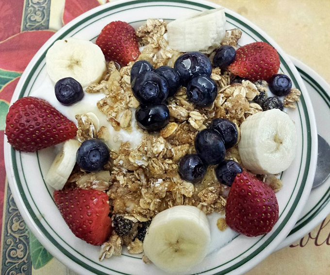 A breakfast parfait that makes you feel virtuous while still indulging. Fresh berries, bananas, and granola prove healthy can be heavenly.