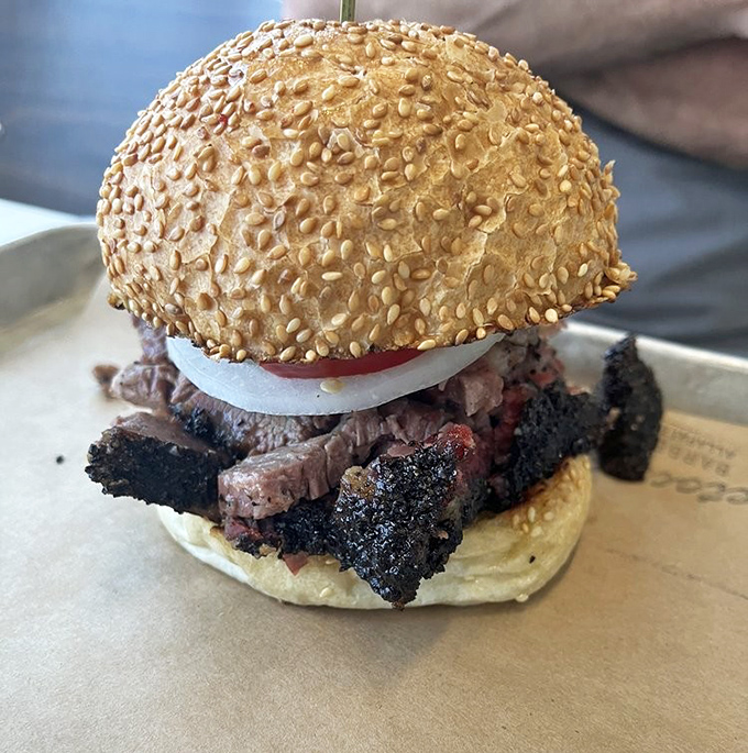 This isn't just a sandwich; it's architecture &ndash; a sesame-studded dome supporting the weight of smoky, bark-crusted brisket glory.