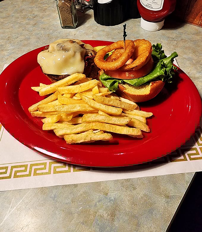 This burger looks like it's ready for its close-up. The onion ring crown adds that touch of royalty every good burger deserves.