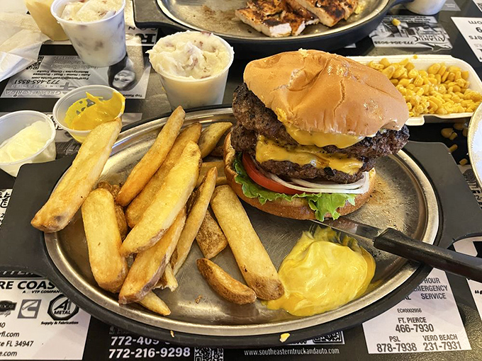 A burger that requires both hands, strategic planning, and possibly a nap afterward. Those fries aren't side characters&mdash;they're co-stars in this production.
