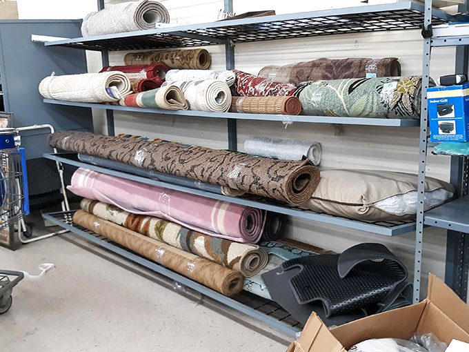 Rolled rugs standing at attention like soldiers, each one ready to transform your bare floor into a statement of second-chance style.