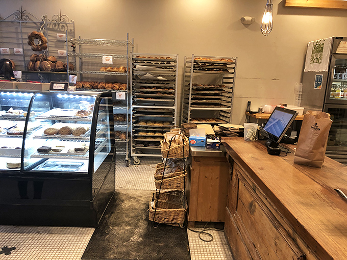 The heart of the operation &ndash; where transactions happen but conversations about bread are always free. The wooden counter has heard countless "Oh my goodness" reactions.