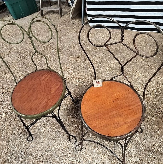 Ice cream parlor chairs with twisted metal backs await new homes. These survivors of countless soda fountain gossip sessions still have stories to tell.