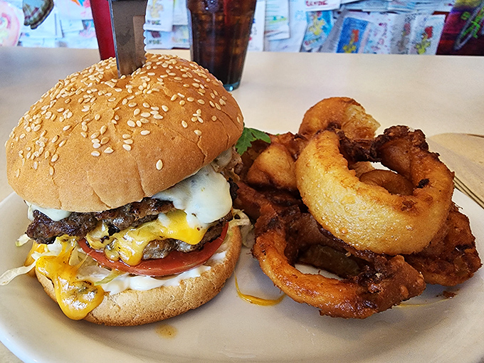 Behold: the burger that launched a thousand napkins. Those onion rings aren't sidekicks&mdash;they're accomplices in delicious crime.