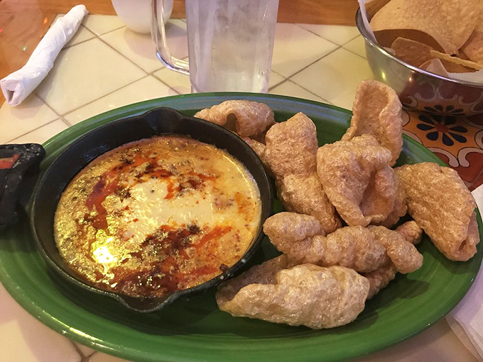 
Queso fundido with chorizo&mdash;where cheese meets its soulmate and creates a dippable masterpiece. Those chicharrones aren't just dippers; they're shovels of joy. 