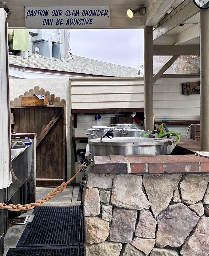 A sign warning of chowder addiction above the very pots that cause the condition. They're not wrong&mdash;I'm already planning my next fix.