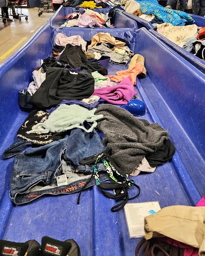 The textile section stretches toward infinity. Each garment waits patiently for someone to recognize its remaining life and value.