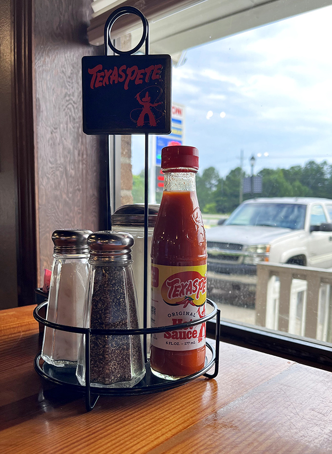 The condiment caddy—that unsung hero of diner dining. Texas Pete stands ready for those who believe breakfast deserves a kick.