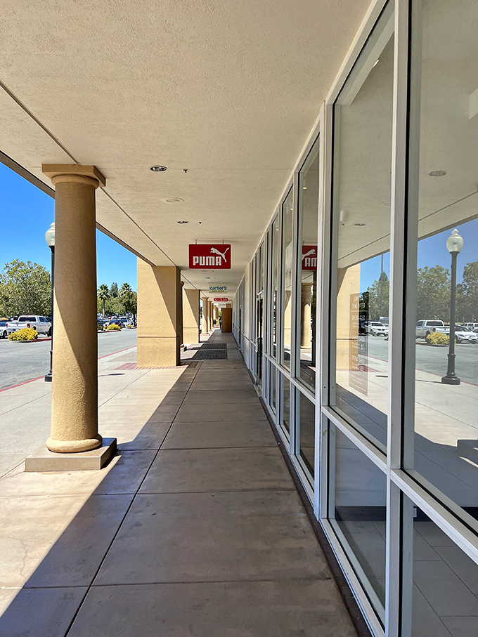 The corridor of possibilities stretches before you like a runway. Each storefront a portal to potential wardrobe transformation.
