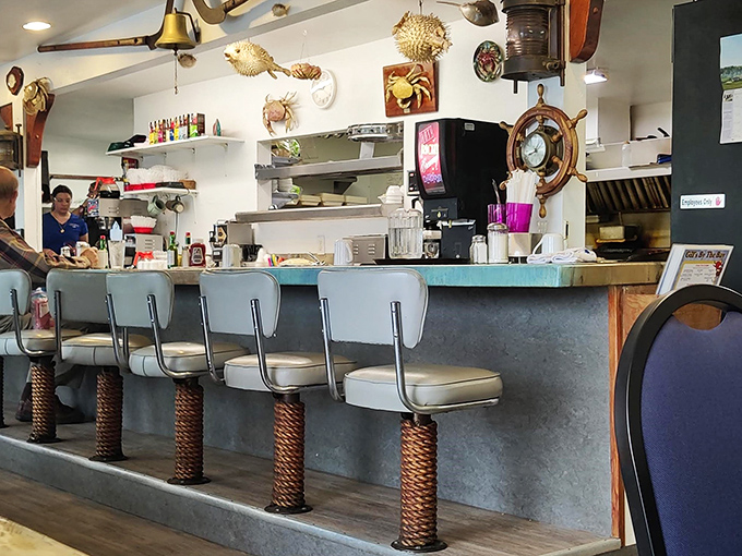 Counter seats: the front-row tickets to the daily seafood symphony, where the blue chairs match the view just outside.