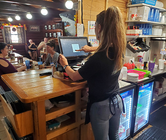 The bustling counter scene where orders fly and friendly banter flows as freely as the sweet tea and barbecue sauce.