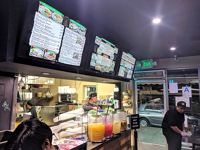 Behind the counter is where the magic happens—colorful aguas frescas lined up like liquid jewels waiting to refresh.