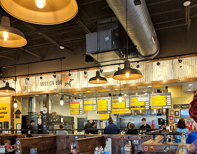 The open kitchen concept lets you witness the choreographed chaos of BBQ artisans at work, turning simple ingredients into smoky masterpieces.