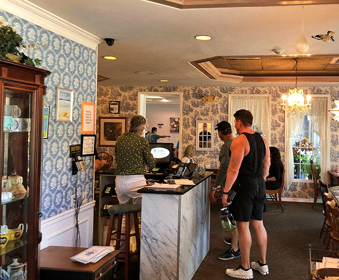 The blue and white toile wallpaper behind the counter whispers "charming" while the marble countertop shouts "come get your breakfast!"