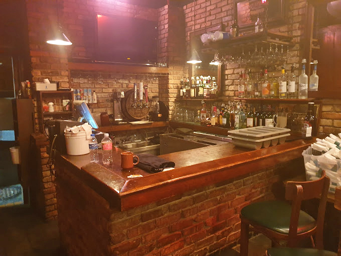 A bar built from honest brick and wood&mdash;where bartenders likely know regulars by name and drink preference without asking.
