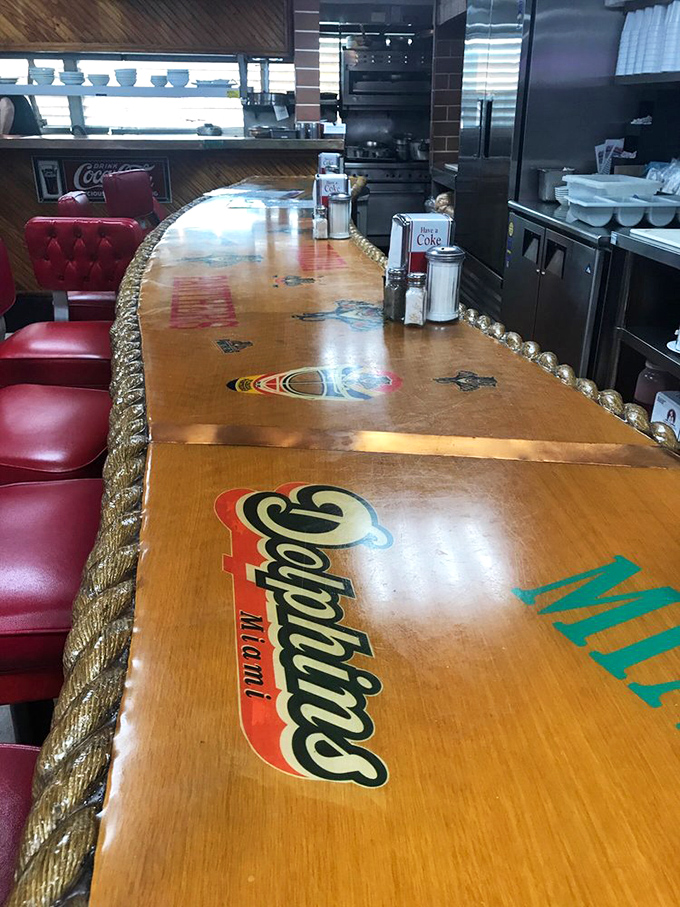 The counter where solo diners find community, decorated with vintage flair and the promise of friendly service just a coffee refill away.