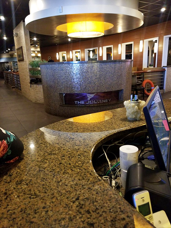 The welcoming counter where your seafood adventure begins. Modern mosaic tiles and warm lighting set the stage for the feast to come.