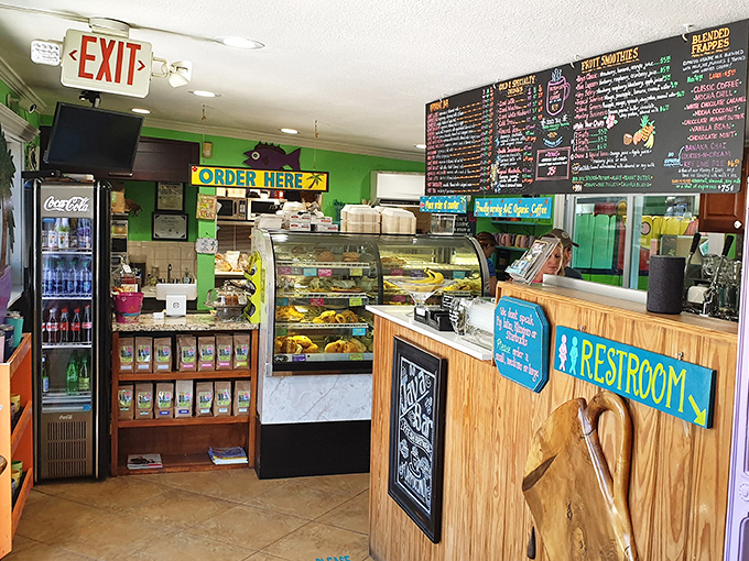 Where the magic happens! The counter area buzzes with activity as pastries tempt from behind glass and colorful signs point the way.