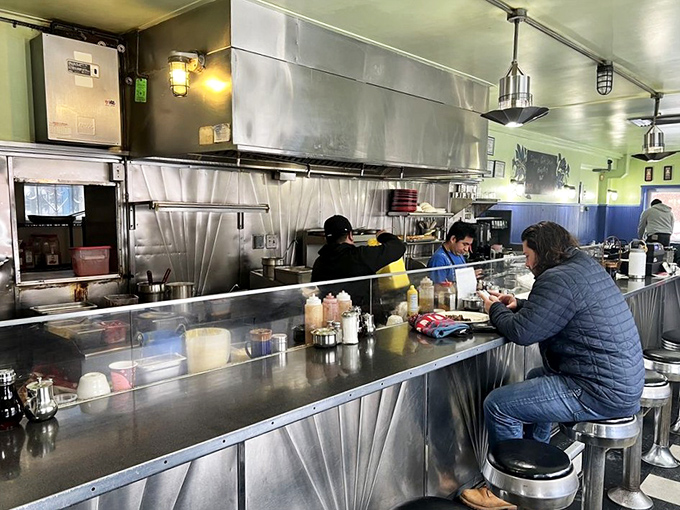 Counter seating: where solo diners become temporary neighbors and the kitchen ballet unfolds before you like delicious performance art.