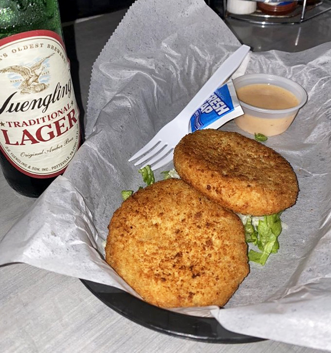 Crab cakes that don't hide behind fillers – just pure, unadulterated seafood goodness that pairs perfectly with a cold Yuengling.