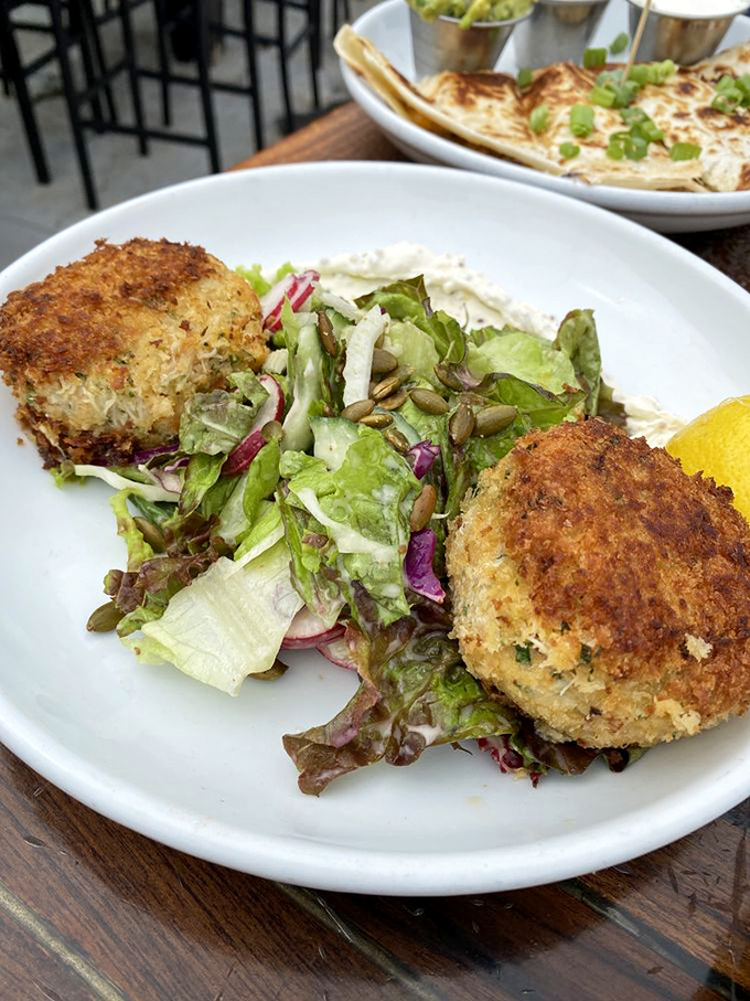 Crab cakes that are actually crab&mdash;not breadcrumbs with a seafood rumor&mdash;served with a salad that doesn't feel like punishment.