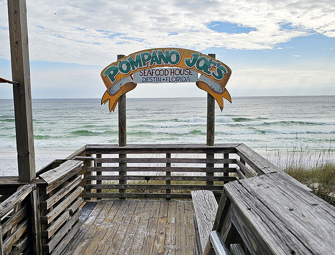 The wooden deck offers front-row seats to nature's greatest show. That sign isn't just announcing a restaurant&mdash;it's promising memories that outlast your sunburn. 