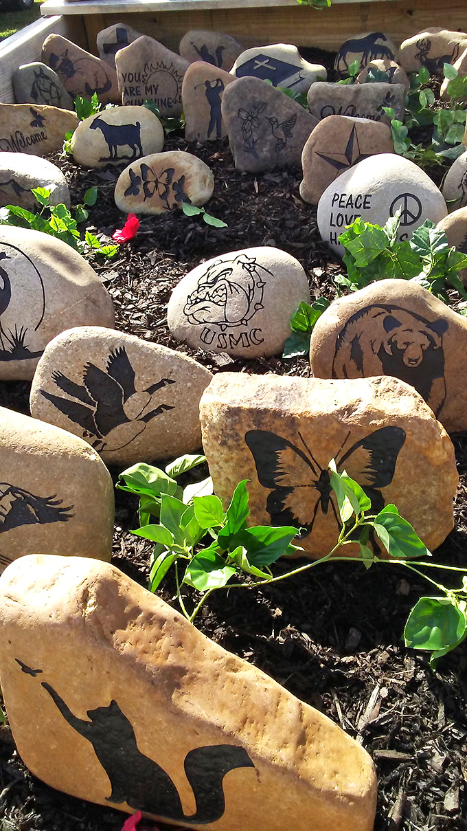 Garden art with messages: where butterflies, peace signs, and military pride coexist in a stone menagerie waiting to personalize your flower bed.