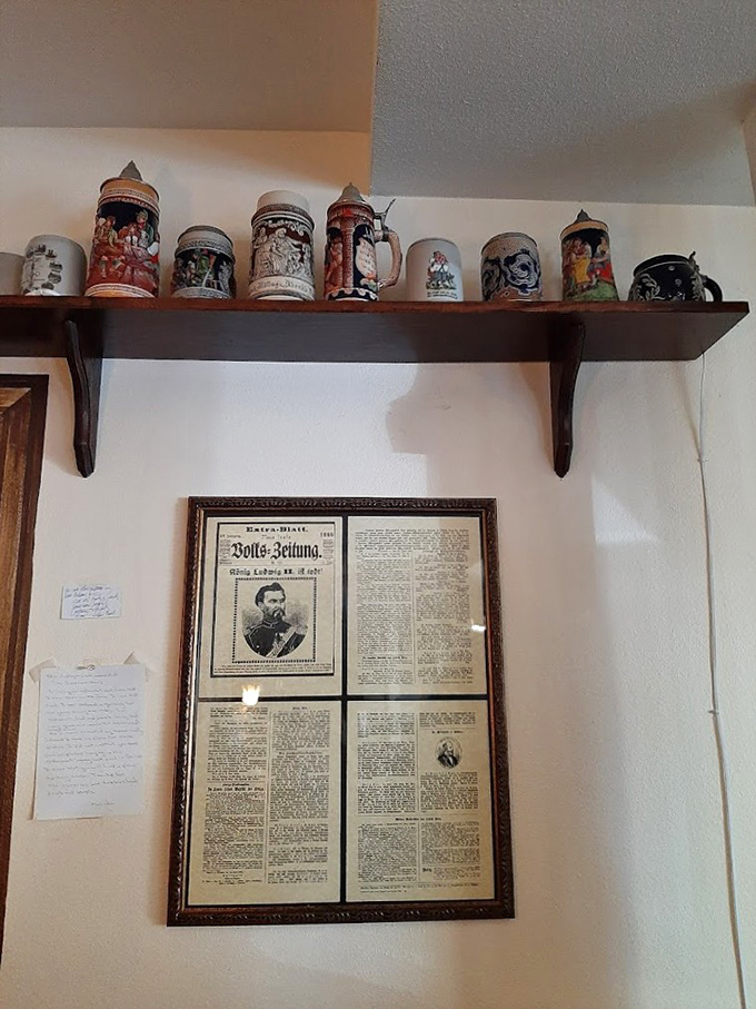 A collection of traditional beer steins stands guard above framed German newspapers&mdash;silent storytellers of heritage and craftsmanship.
