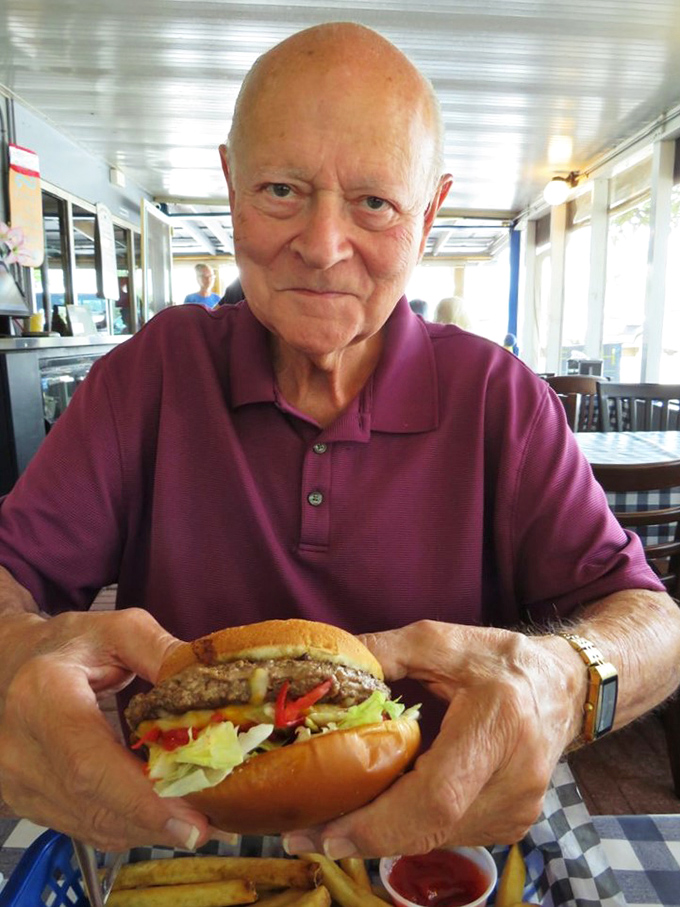 The burger in this patron's hands isn't just lunch&mdash;it's the reason smartphones were invented to make friends jealous..