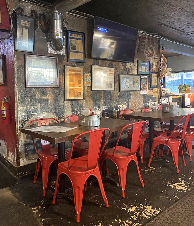 Red metal chairs pop against weathered walls &ndash; industrial chic before it was trendy, authentic because it has to be.