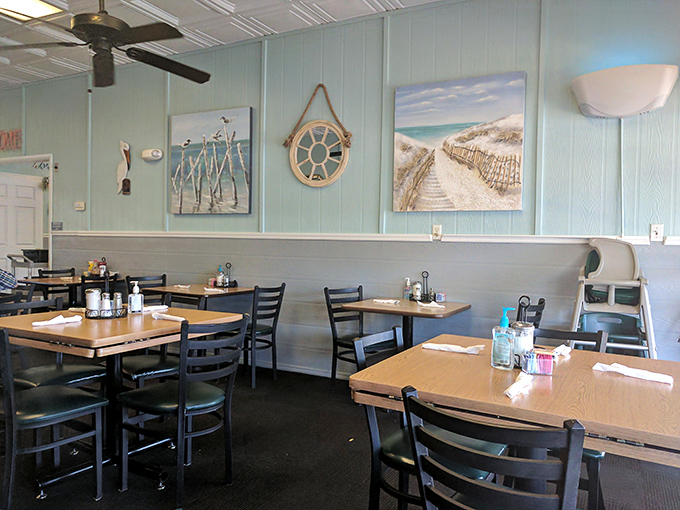 Simple wooden tables, comfortable chairs, and coastal artwork create the perfect backdrop for the real star of the show—whatever's on your plate.