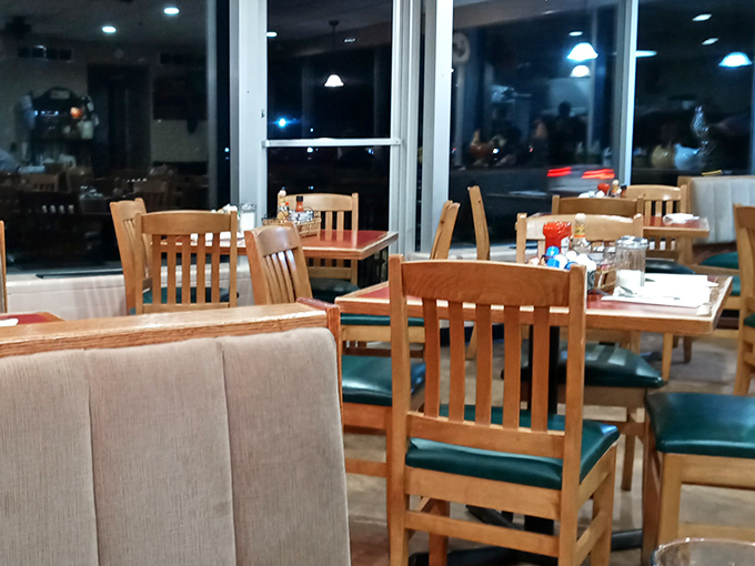 Evening light streams through large windows, transforming this humble diner into a cozy haven where comfort food and conversation are always on the menu.