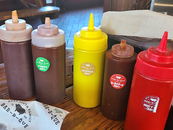 A rainbow of sauces awaits, each bottle promising a different path to barbecue enlightenment.