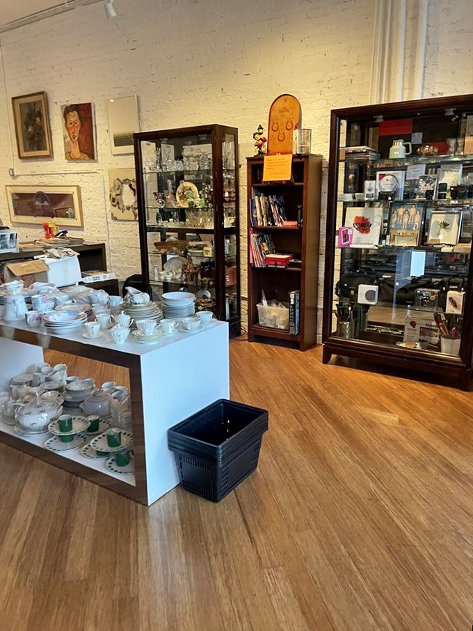 Fine china and collectibles displayed with care. Someone's grandmother's teacup set awaits a new home where afternoon tea might once again become a cherished ritual.