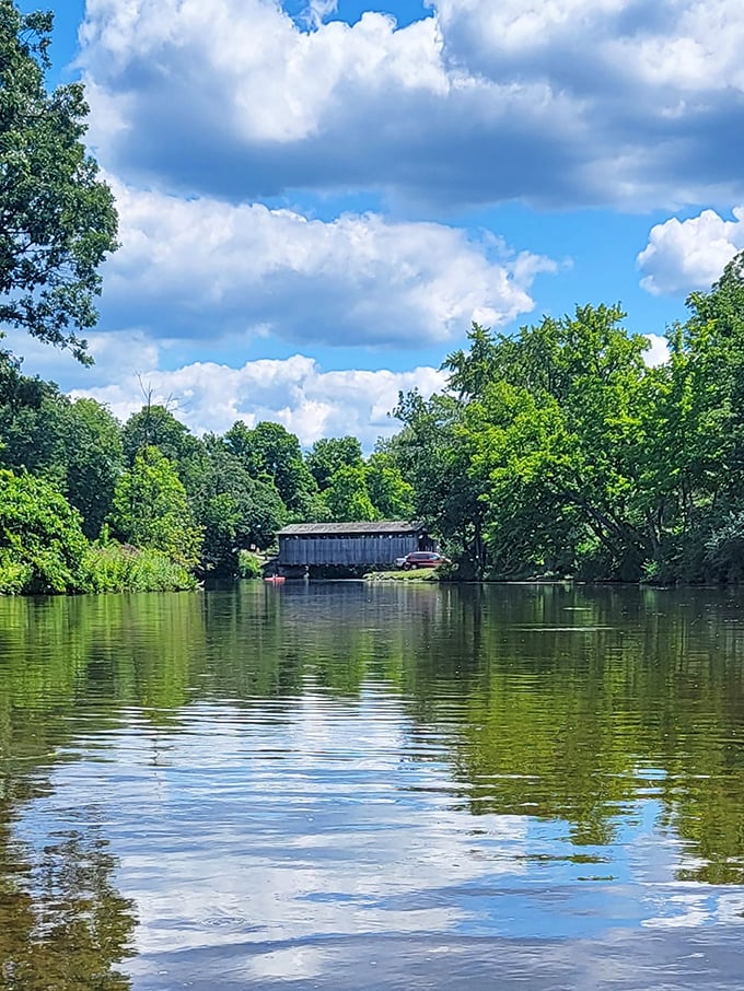 A bridge between worlds. From the water, Fallasburg appears to float between reflections of sky and trees in perfect Michigan serenity.