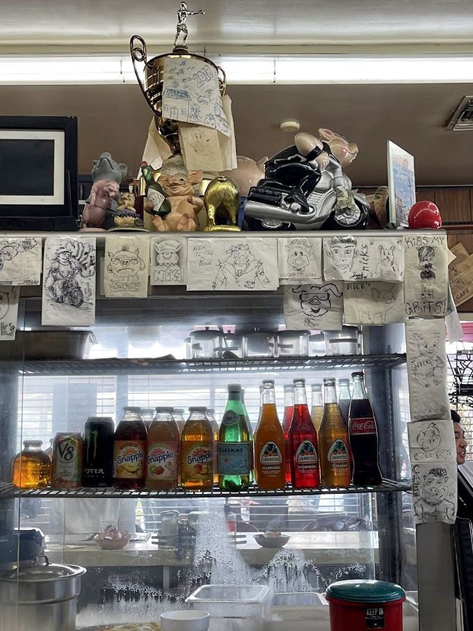 A shrine to nostalgia sits above colorful bottles of soda. Those hand-drawn napkin sketches and collected trinkets represent decades of customers leaving their mark.