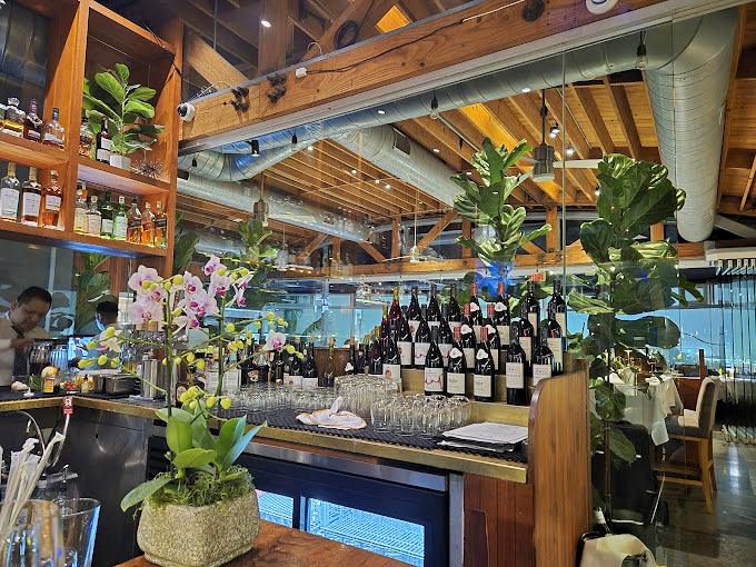 Where wine meets design – this bar corner blends bottles, blooms and wood in a display that's equal parts function and California cool.